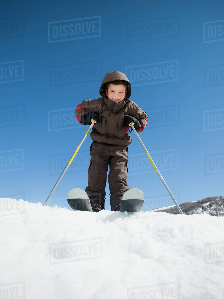 Boy standing on skis - Royalty-free Stock Photo | Dissolve