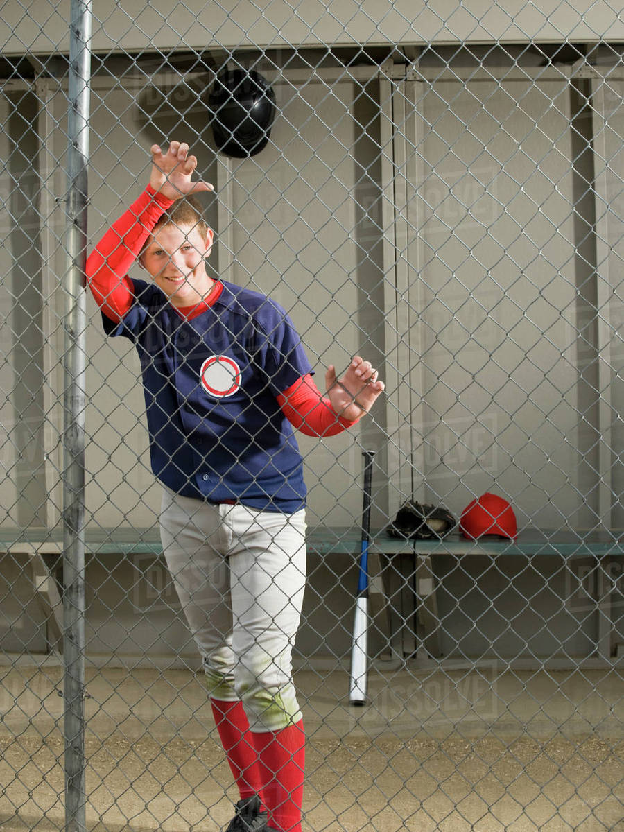 Baseball player standing in dugout - Royalty-free Stock Photo | Dissolve