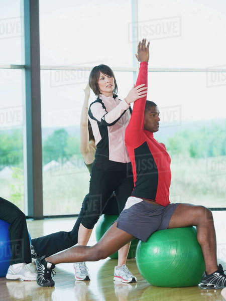 Instructor guiding fitness class - Royalty-free Stock Photo | Dissolve