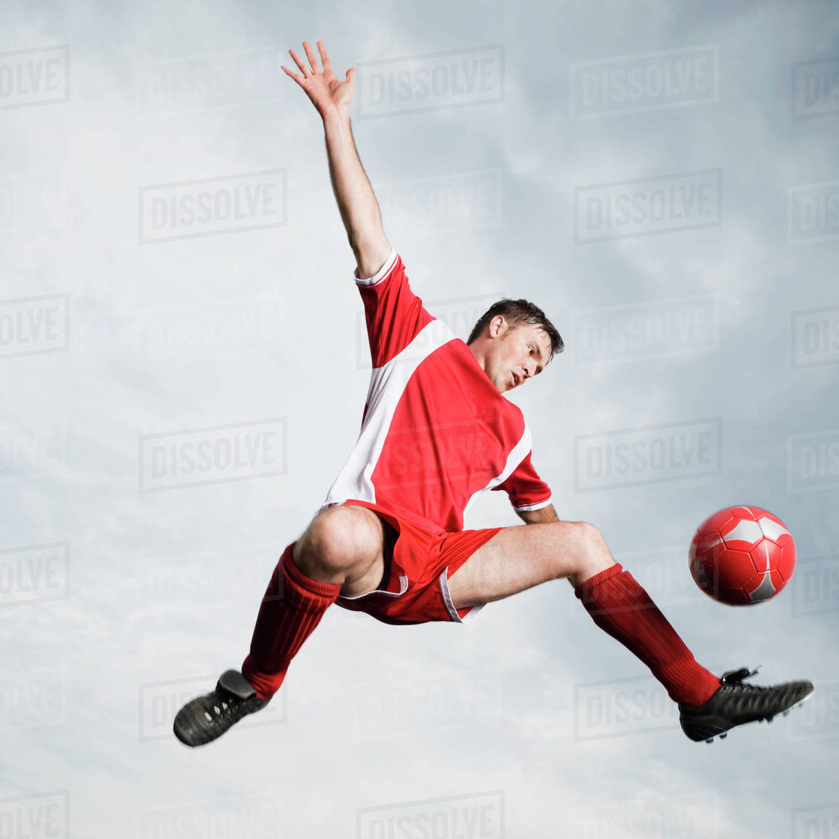Soccer player kicking soccer ball in mid-air - Royalty-free Stock Photo ...