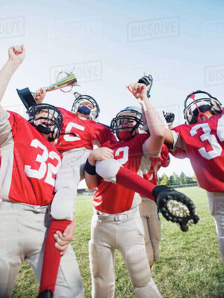 Football team with trophy celebrating - Royalty-free Stock Photo | Dissolve