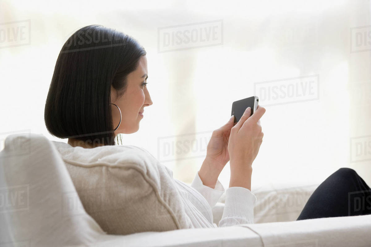 Woman looking at cell phone - Royalty-free Stock Photo | Dissolve