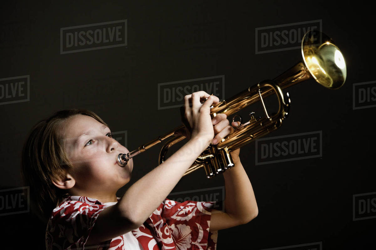 Boy playing trumpet - Stock Photo - Dissolve