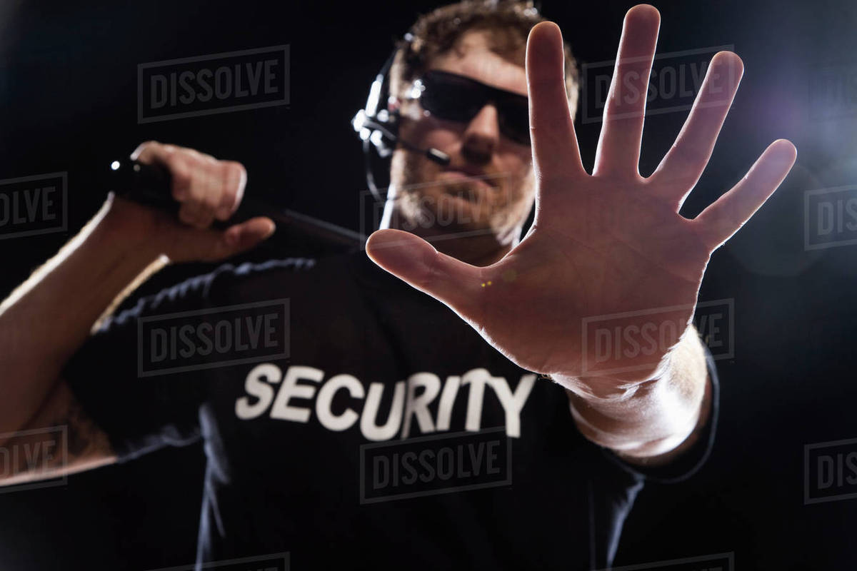 Security guard extending hand - Royalty-free Stock Photo | Dissolve
