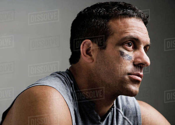 Close up of football player looking disappointed - Stock Photo - Dissolve