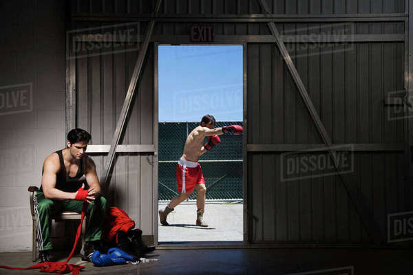 Boxers wrapping hands and practicing - Royalty-free Stock Photo | Dissolve