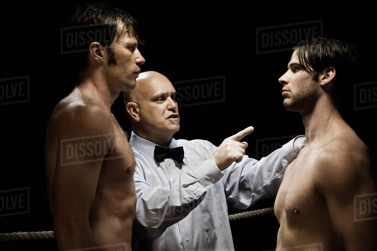 Referee standing between two boxers - Royalty-free Stock Photo | Dissolve