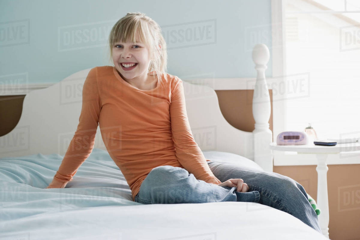 Girl sitting on bed - Royalty-free Stock Photo | Dissolve