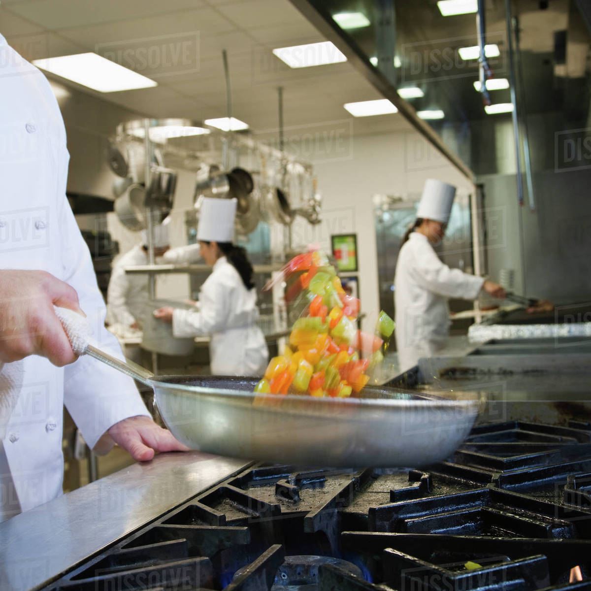 Chef tossing food in skillet - Royalty-free Stock Photo | Dissolve