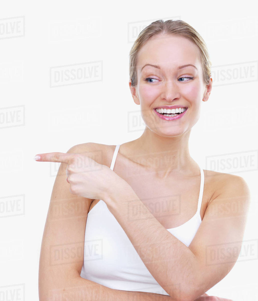 Woman pointing to side - Royalty-free Stock Photo | Dissolve