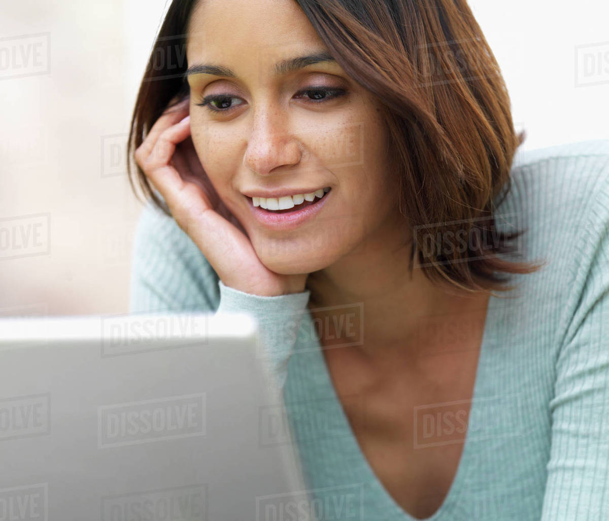 Woman looking at laptop - Stock Photo - Dissolve