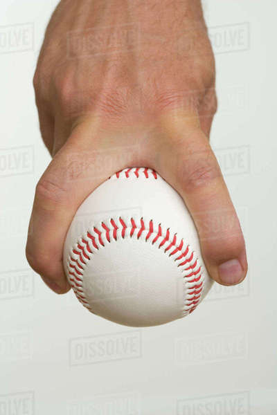 Close up of pitcher holding baseball - Stock Photo - Dissolve