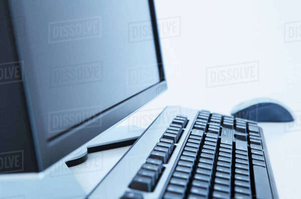 Close up of computer on desk - Royalty-free Stock Photo | Dissolve