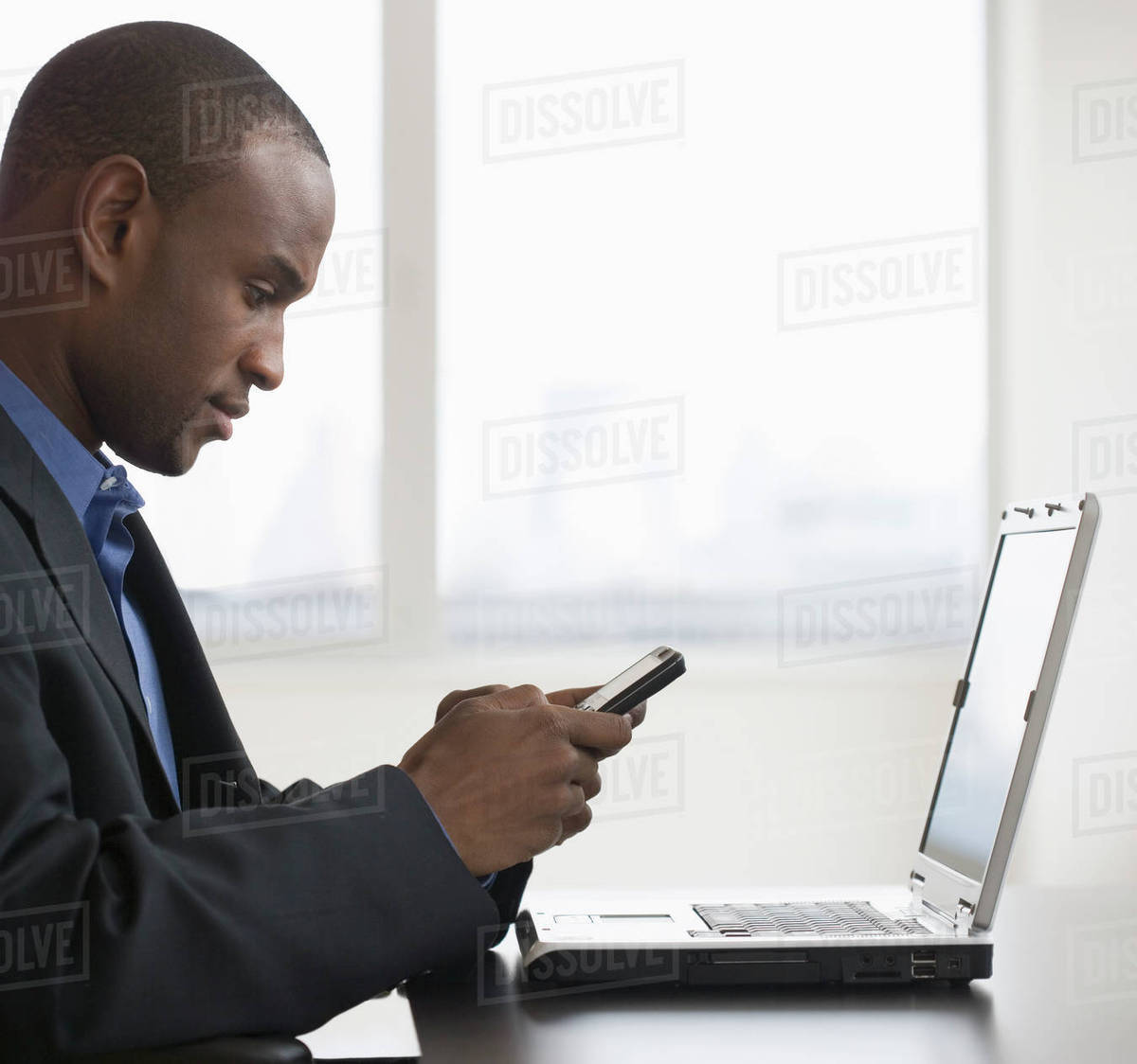 Businessman dialing cell phone - Royalty-free Stock Photo | Dissolve