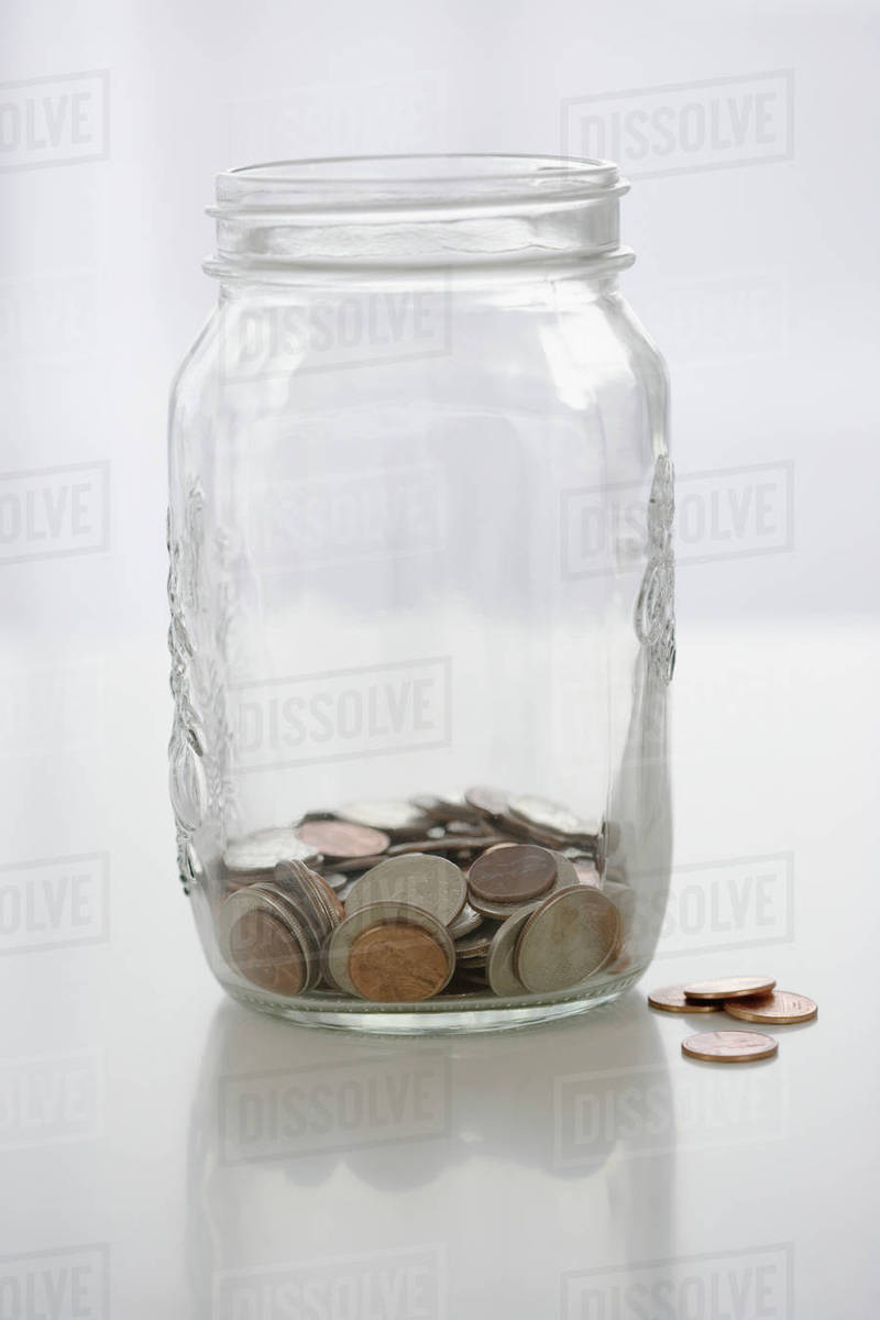 Mason jar with change - Stock Photo - Dissolve