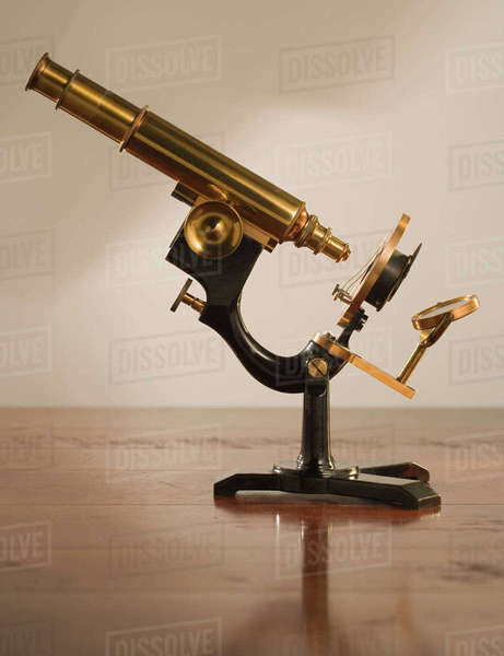 Old fashioned microscope on table - Royalty-free Stock Photo | Dissolve