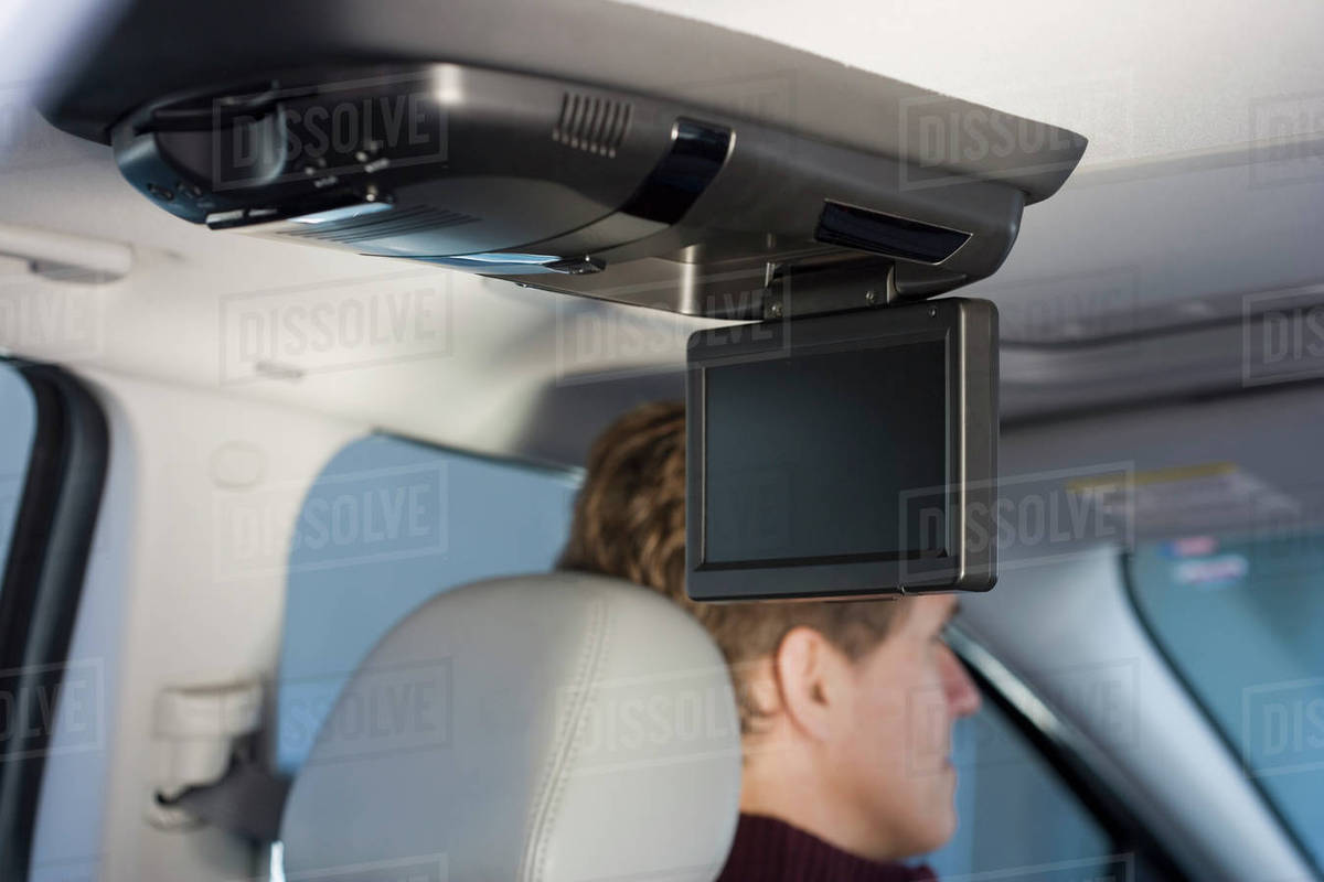 Television screen in car with man driving - Stock Photo - Dissolve