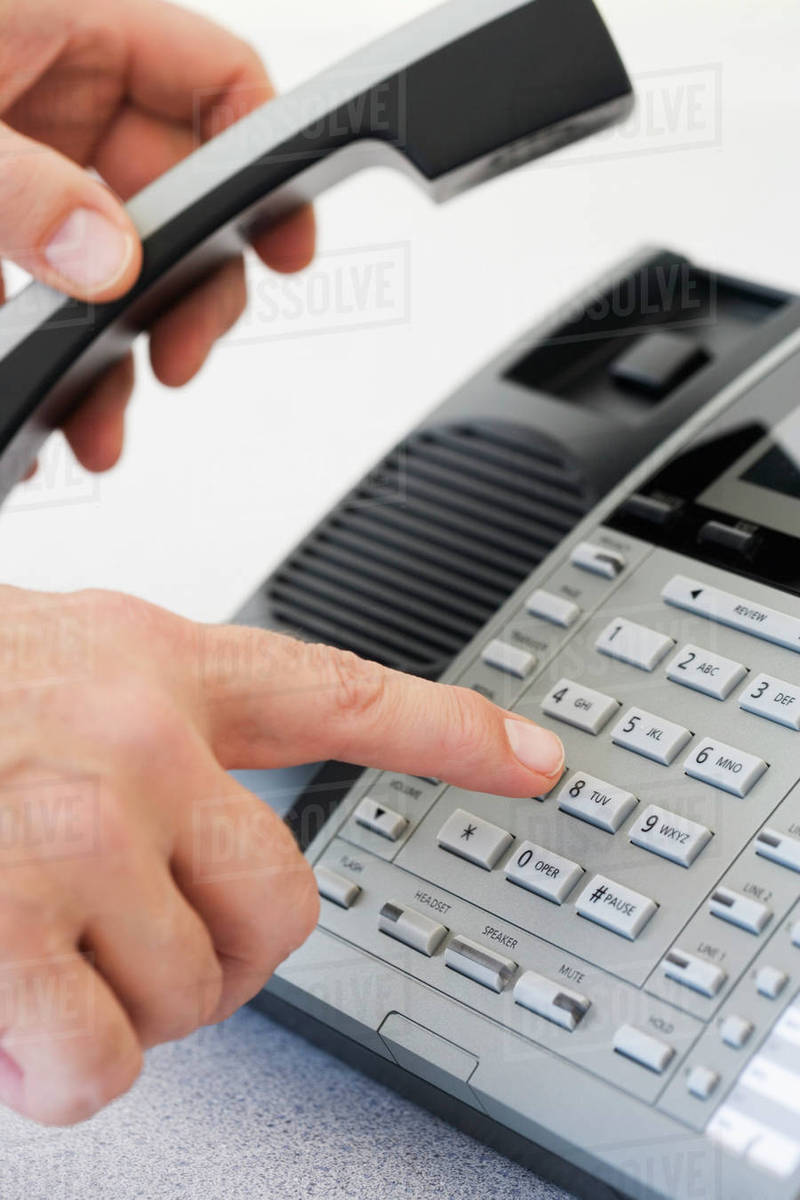 Man dialing telephone - Royalty-free Stock Photo | Dissolve