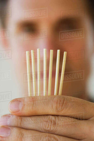 Man holding toothpicks - Royalty-free Stock Photo | Dissolve