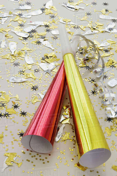 Party noisemakers and confetti - Stock Photo - Dissolve