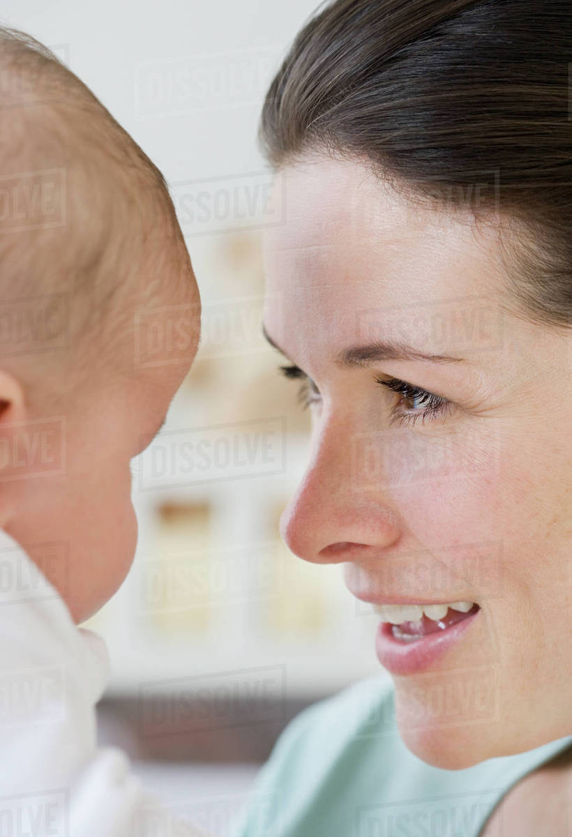 Mother smiling at baby - Stock Photo - Dissolve