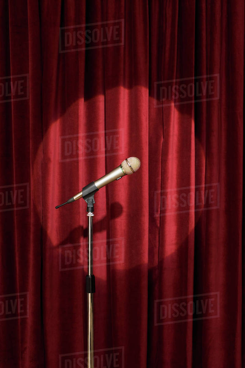 Spotlight on microphone on stage - Stock Photo - Dissolve
