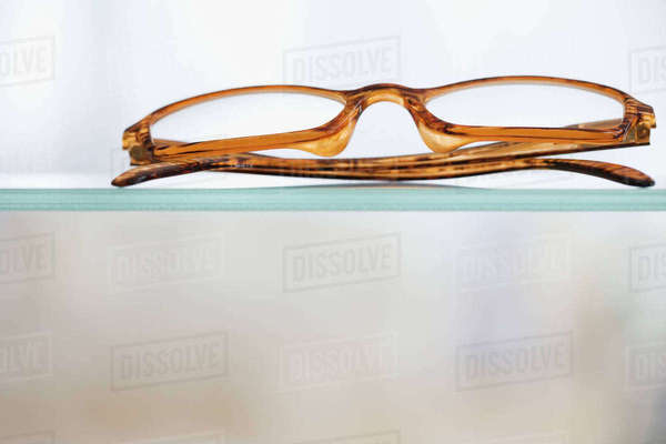 Close up of eye glasses on shelf - Royalty-free Stock Photo | Dissolve