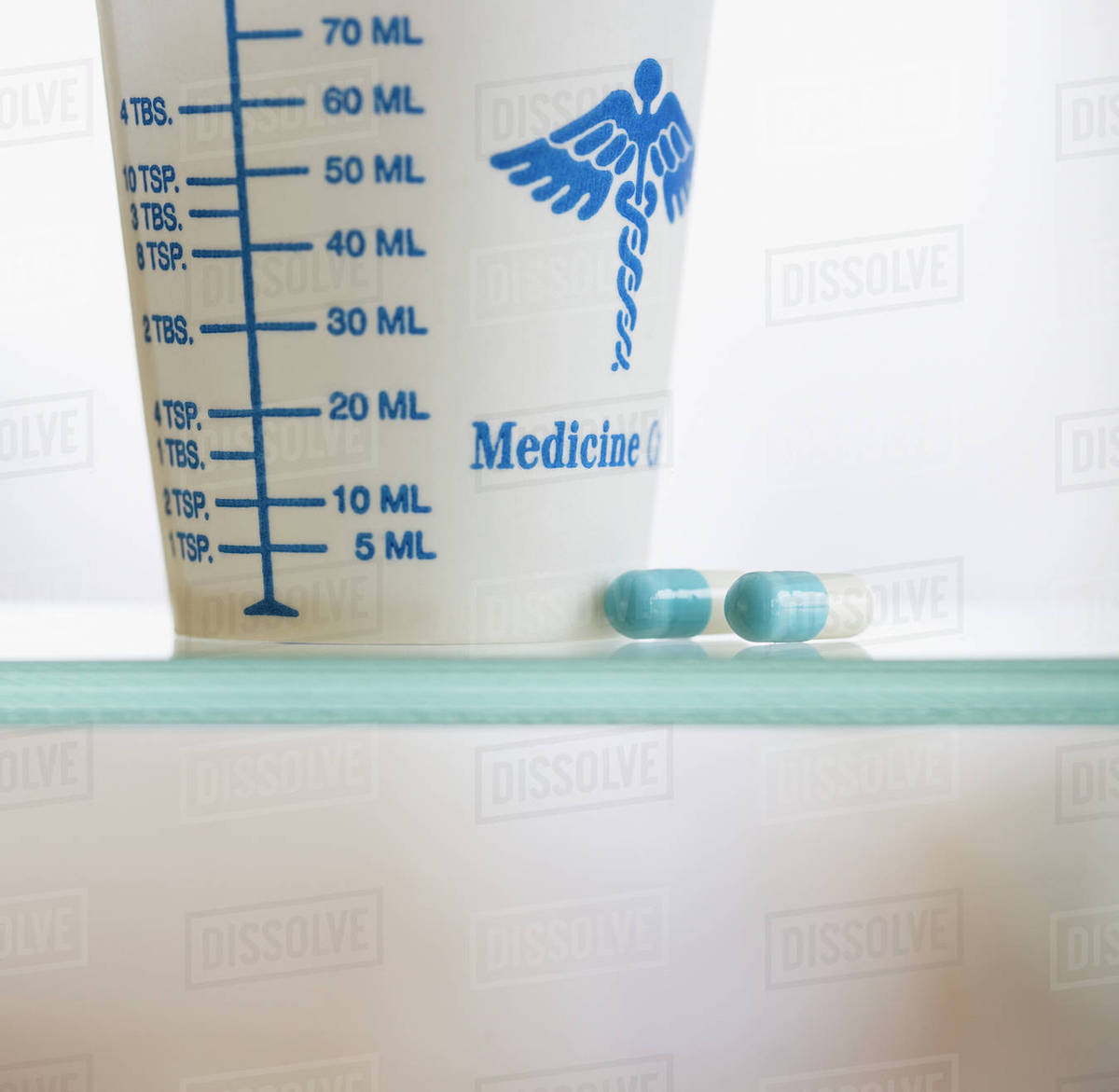 Medication and cup on shelf - Royalty-free Stock Photo | Dissolve