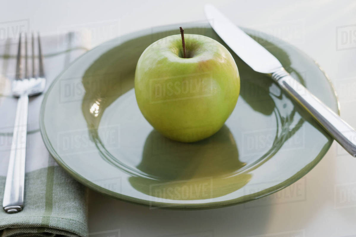 Apple on plate - Stock Photo - Dissolve