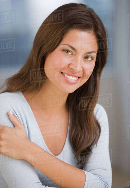 Asian woman with hand on arm - Royalty-free Stock Photo | Dissolve
