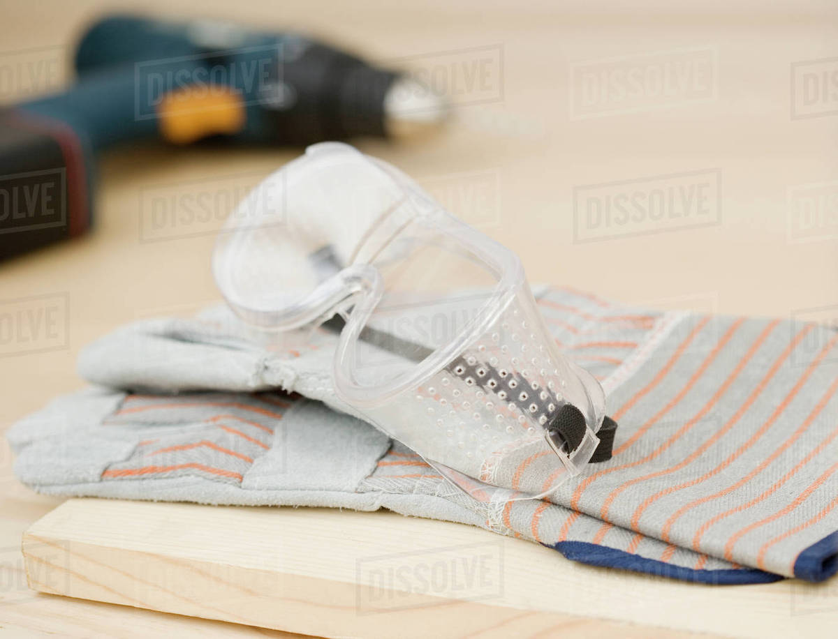 Close up of safety goggles and gloves - Stock Photo - Dissolve