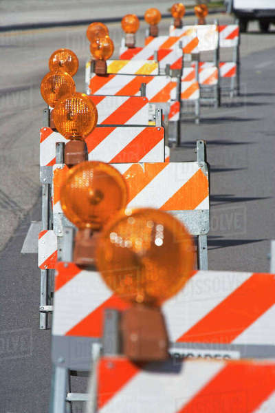 Row of traffic barricades with lights - Stock Photo - Dissolve