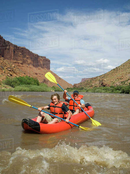 People paddling in raft - Stock Photo - Dissolve