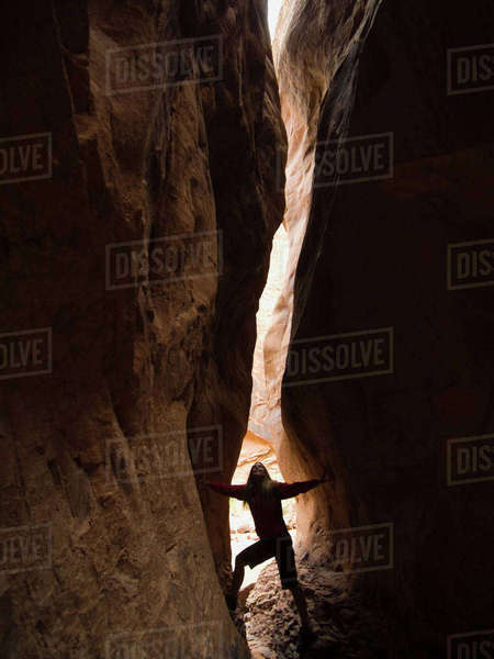 Woman looking up between rock formations - Royalty-free Stock Photo ...