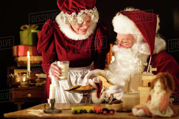 Mrs. Claus bringing homemade cookies to Santa Claus - Royalty-free ...