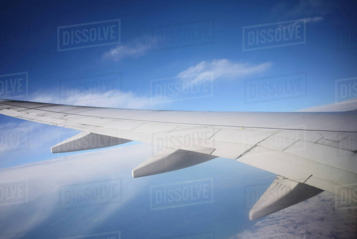 Cropped image of airplane in sky - Royalty-free Stock Photo | Dissolve