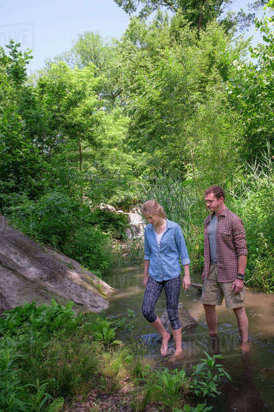 Couple wading in water - Royalty-free Stock Photo | Dissolve
