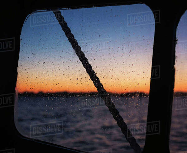 Sea at sunset seen through boat window - Stock Photo - Dissolve
