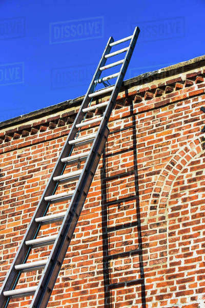 Ladder by brick wall - Royalty-free Stock Photo | Dissolve