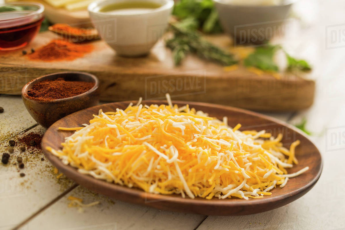 Shredded cheese on wooden plate - Royalty-free Stock Photo | Dissolve