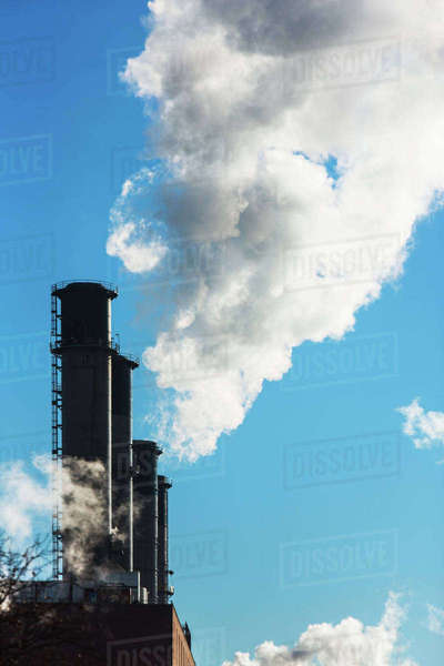 Smokestacks releasing smoke - Stock Photo - Dissolve