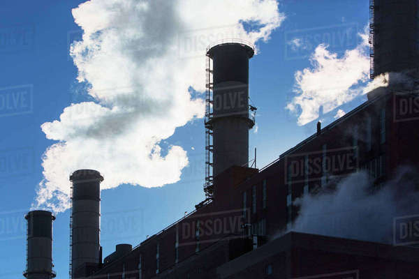 Smokestack releasing smoke - Royalty-free Stock Photo | Dissolve