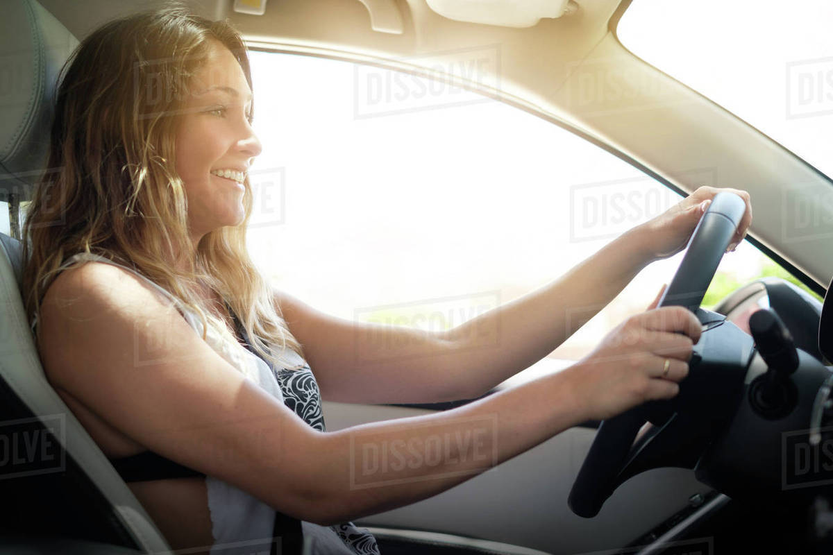 Happy woman driving - Royalty-free Stock Photo | Dissolve