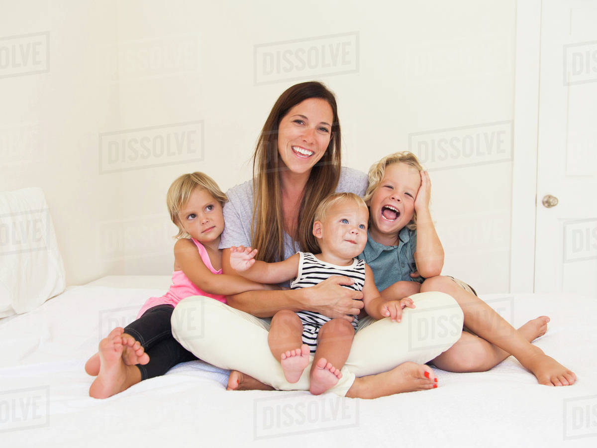 Mother with three kids (6-7, 2-3, 6-11 months) - Royalty-free Stock ...