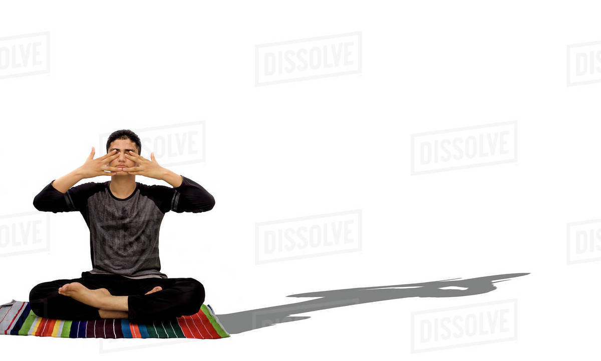 Full body shot of male teenager doing Bhramari Pranayama or Human ...