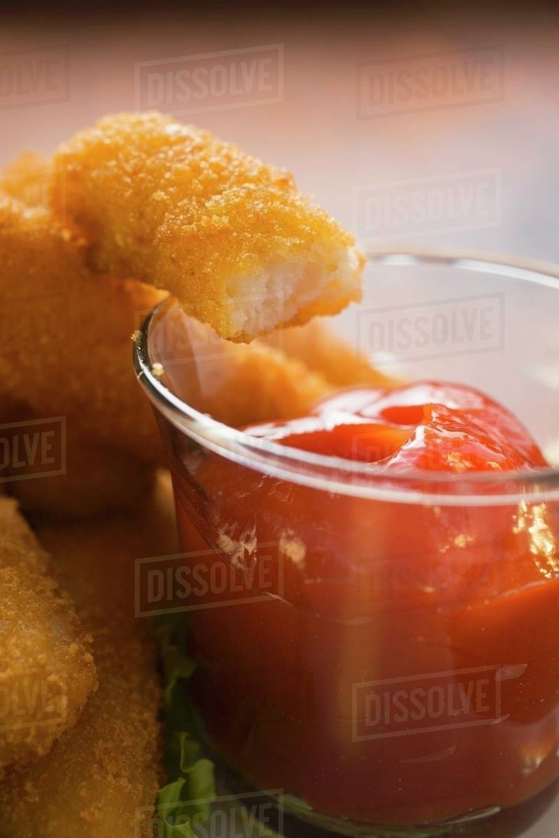 Fish finger with ketchup (a bite taken) - Royalty-free Stock Photo ...