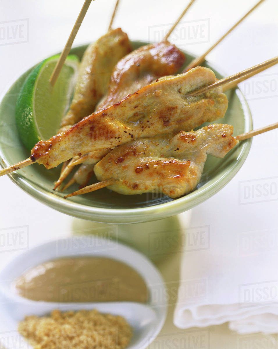 Chicken sate with peanut sauce - Stock Photo - Dissolve