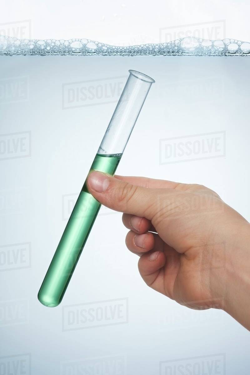 A hand holding a test tube of washing up liquid - Royalty-free Stock ...