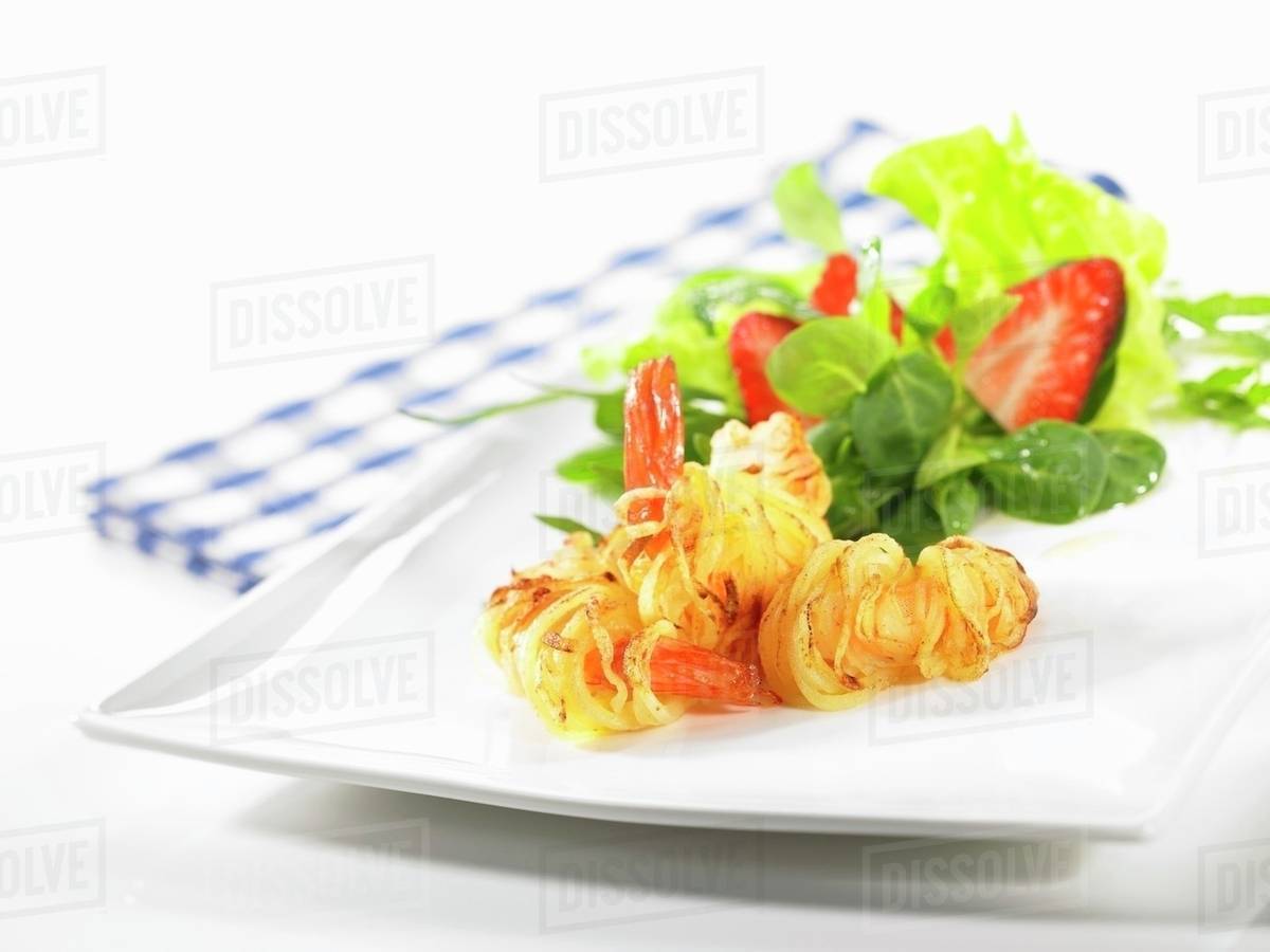 Prawns wrapped in potato on a spring salad with a white balsamic ...