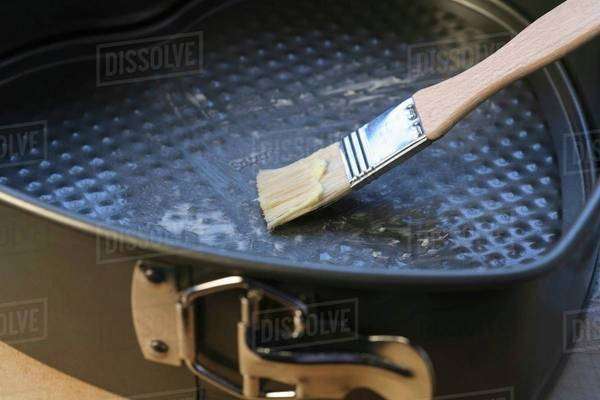 Greasing a baking tin - Royalty-free Stock Photo | Dissolve